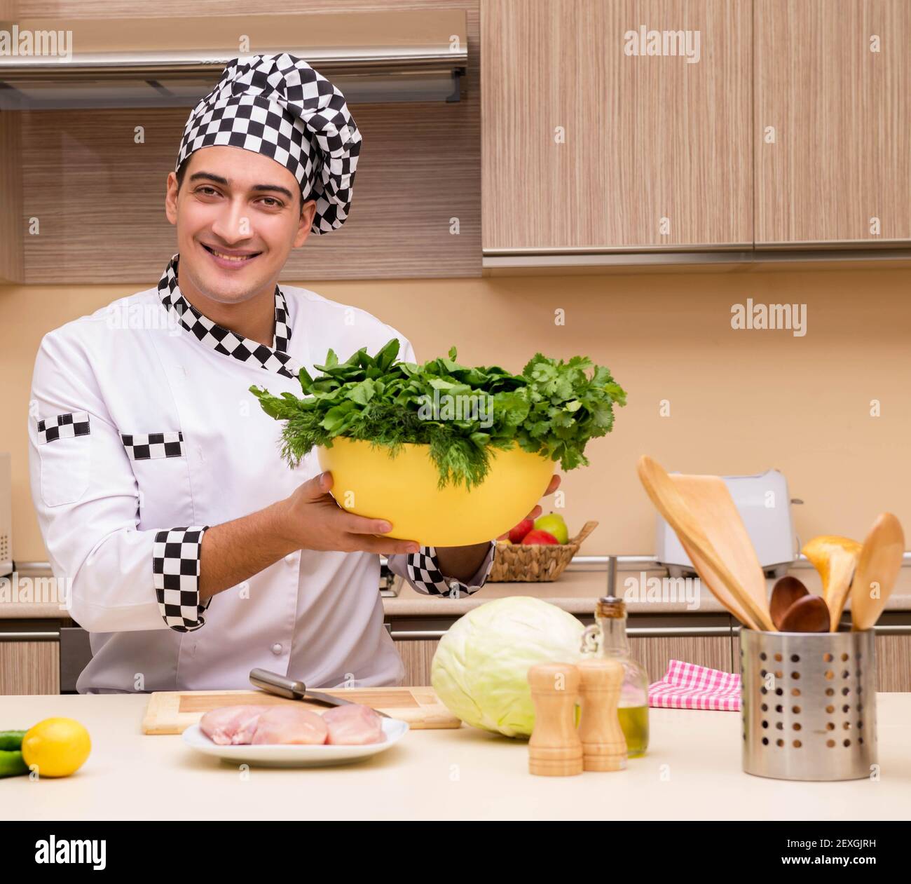 The young chef working in the kitchen Stock Photo - Alamy