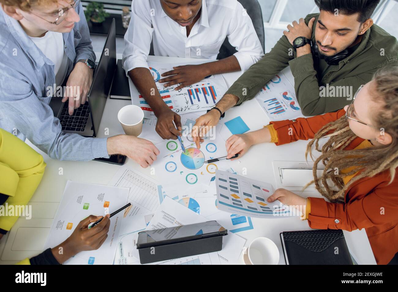 Creative diverse students analysing project plan at office Stock Photo ...