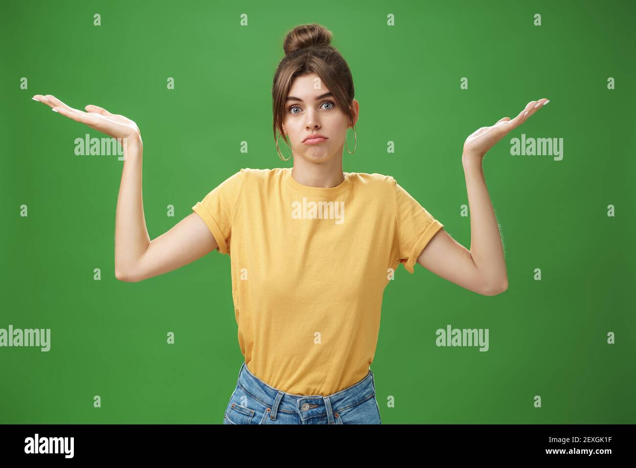 Girl do not know anything. Portrait of confused unsure cute woman with ...