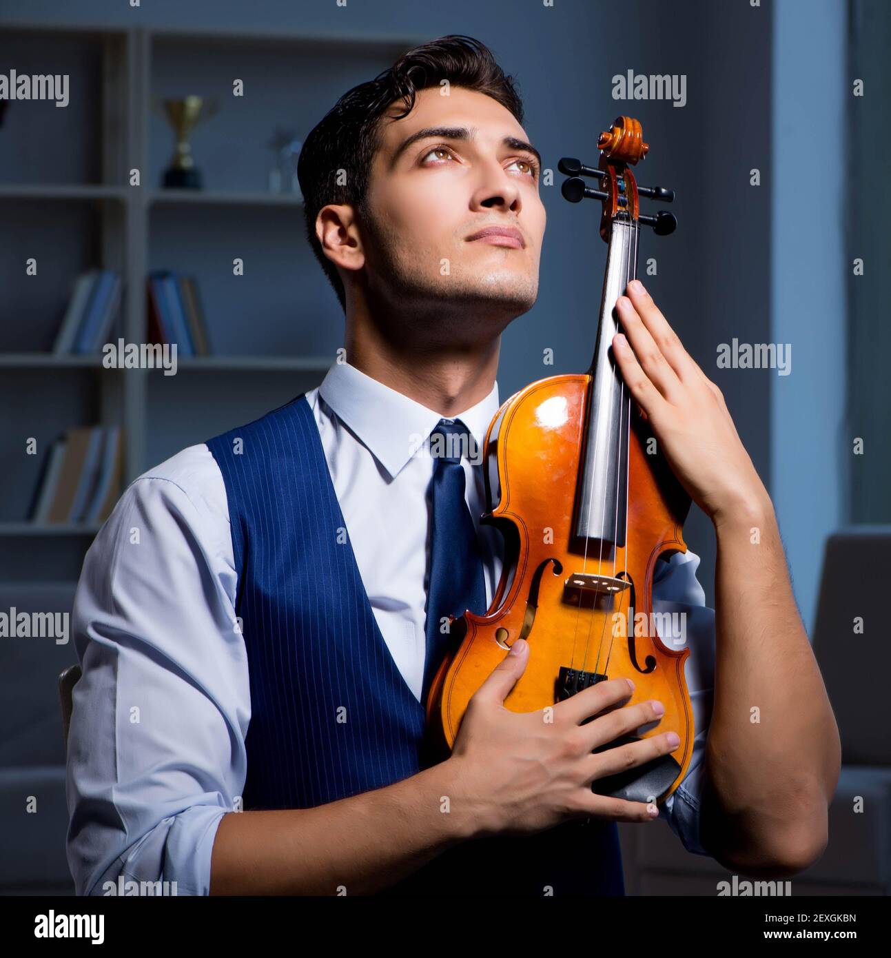 The young musician man practicing playing violin at home Stock Photo ...