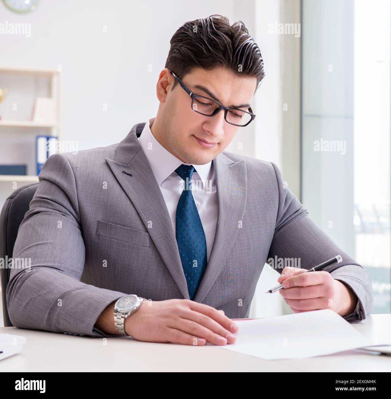 The businessman signing business documents in office Stock Photo - Alamy