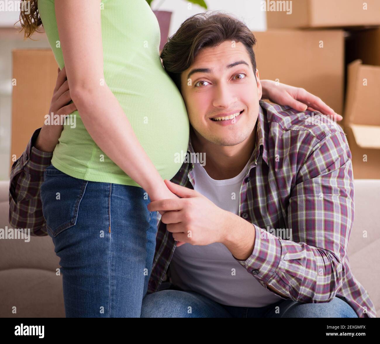 The young couple of man and pregnant wife expecting baby Stock Photo ...