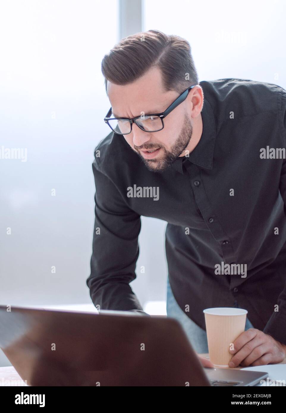 Young man looks laptop monitor hi-res stock photography and images - Alamy