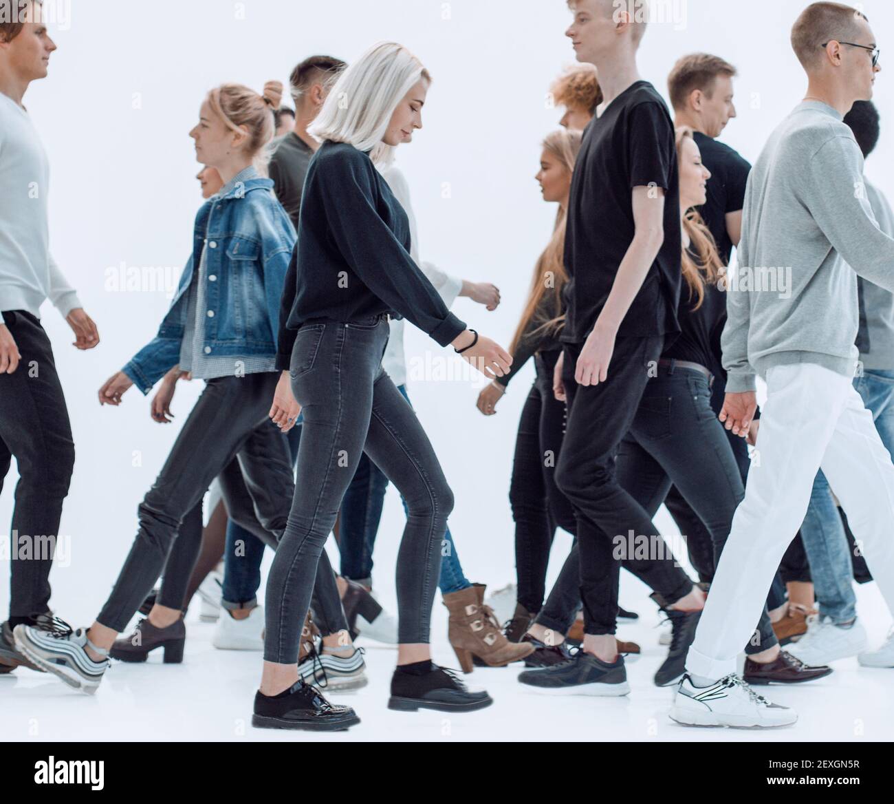 in full growth. diverse young people walking in different directions ...