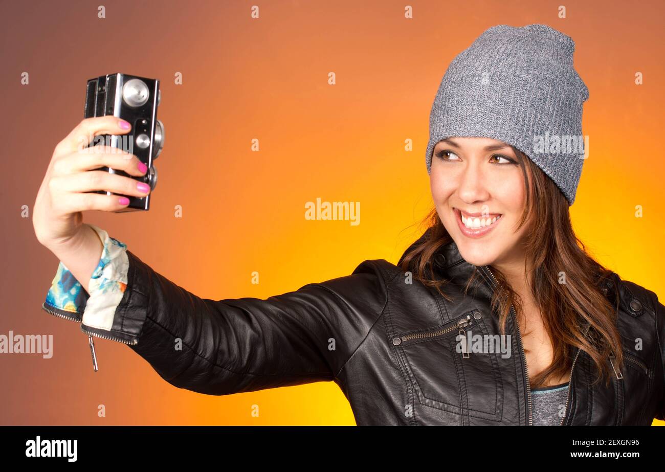 Hip Woman Snaps a Self Portrait with Vintage Camera Stock Photo - Alamy