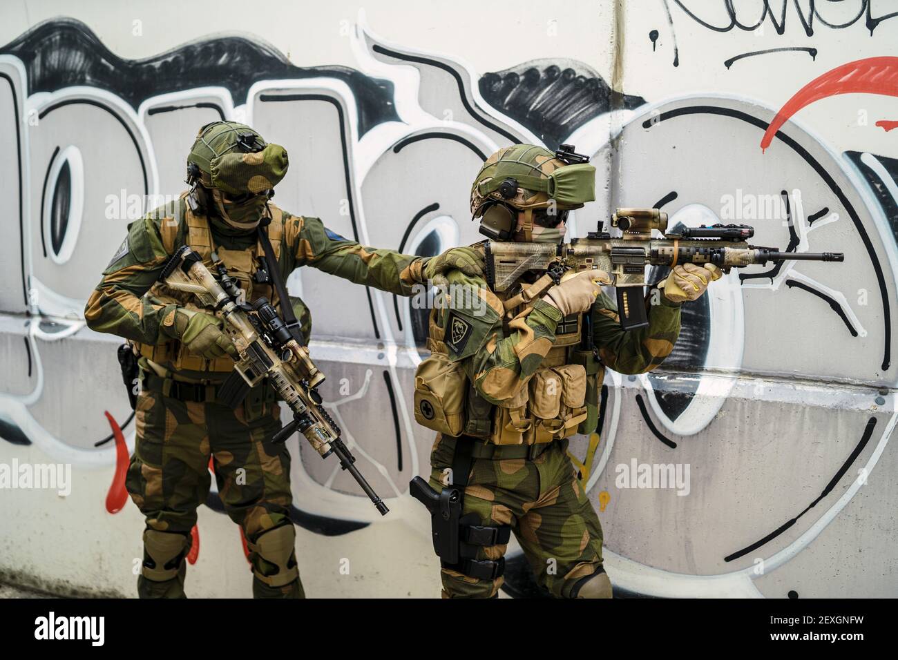 A special force soldier signalling his partner by tapping on his ...