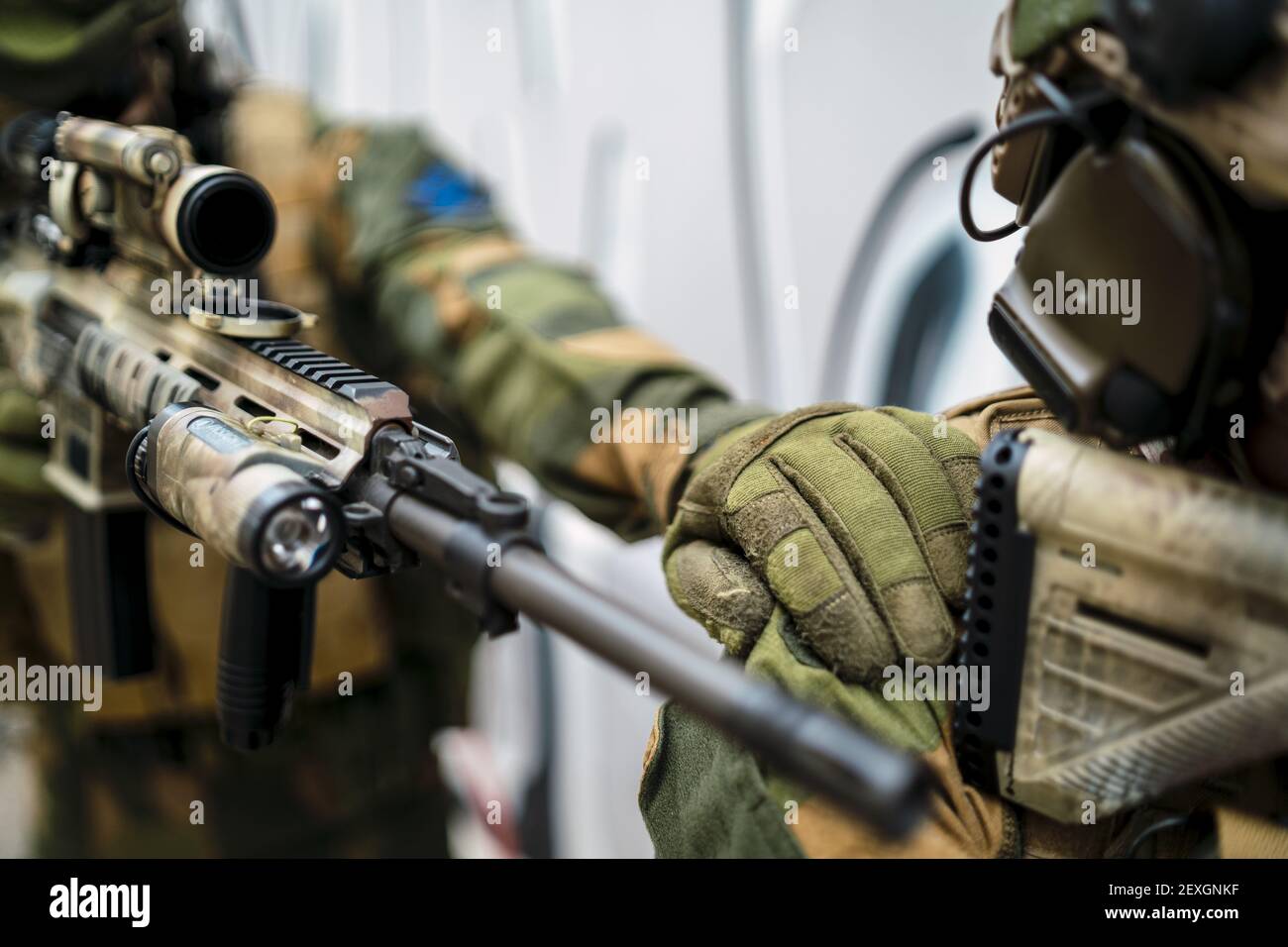 A special force soldier signalling his partner by tapping on his ...