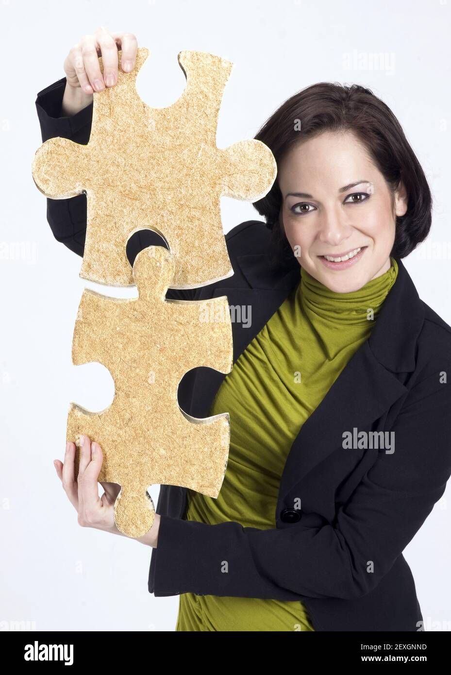Woman Working With Two Large Jigsaw Puzzle Pieces Stock Photo - Alamy