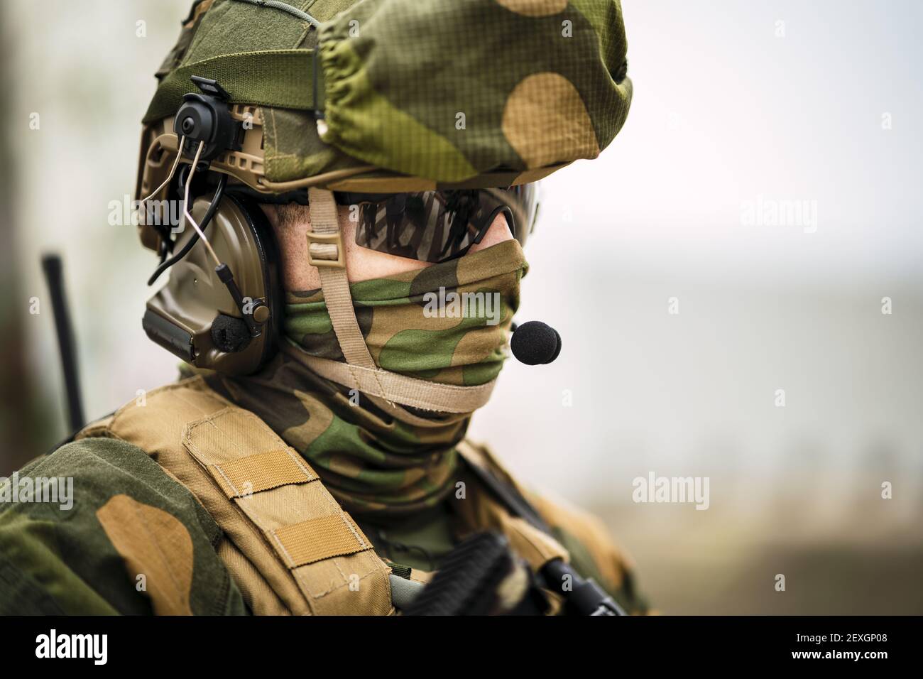 A shallow focus of a special force soldier in camouflage during a ...
