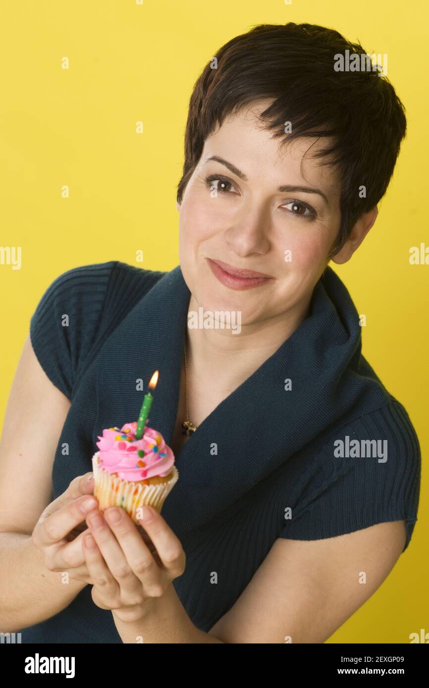 Person with cupcake and candle hi-res stock photography and images - Alamy