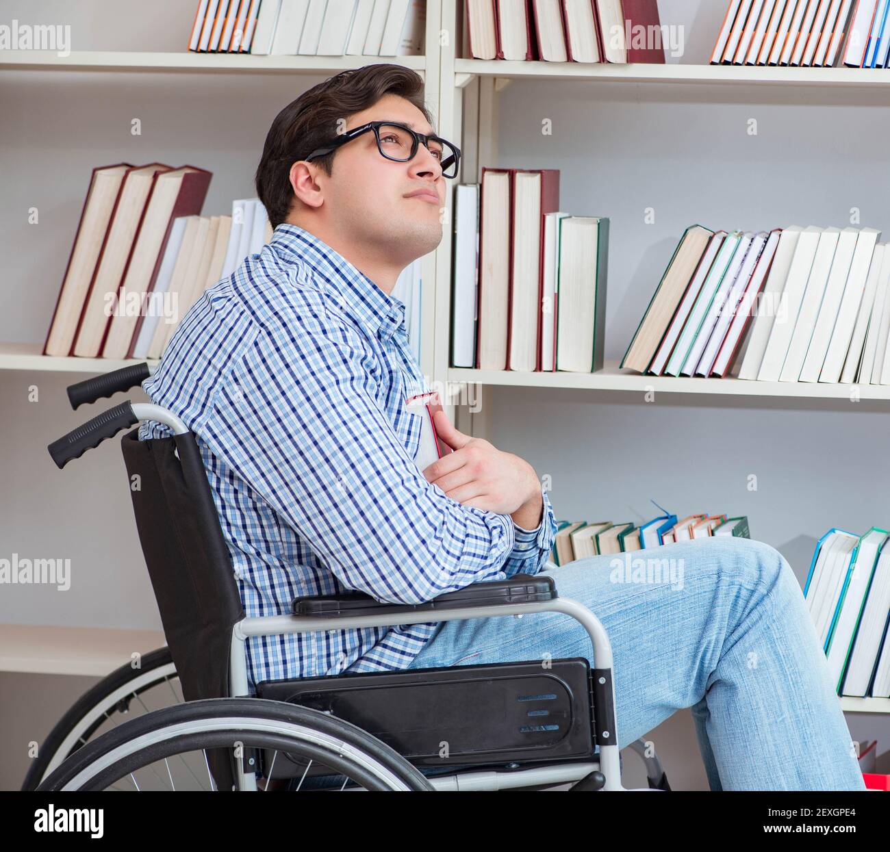 The disabled student studying in the library Stock Photo - Alamy
