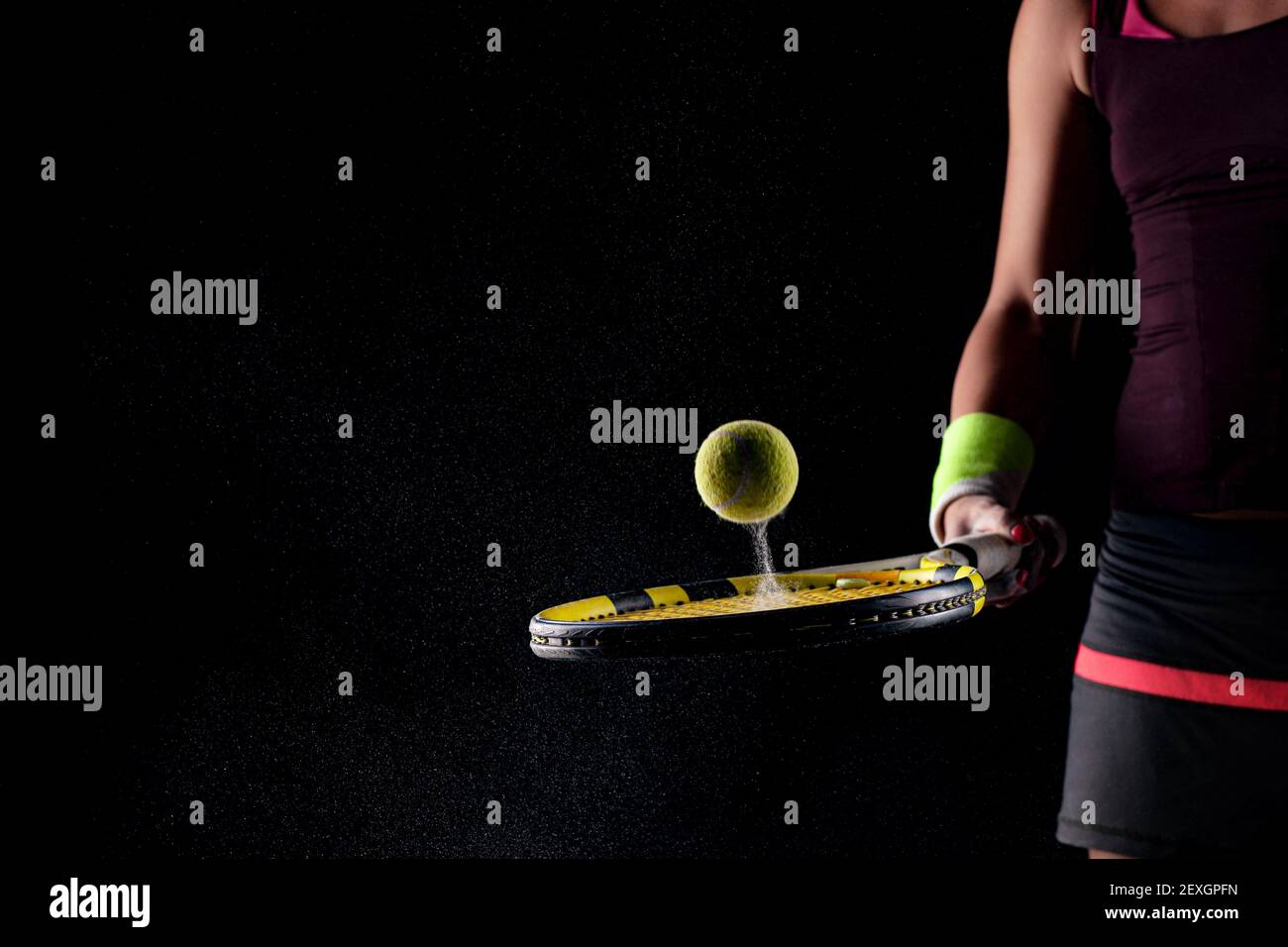 Tennis ball bouncing on racket. Dirt or magnesium dust dots visible in ...