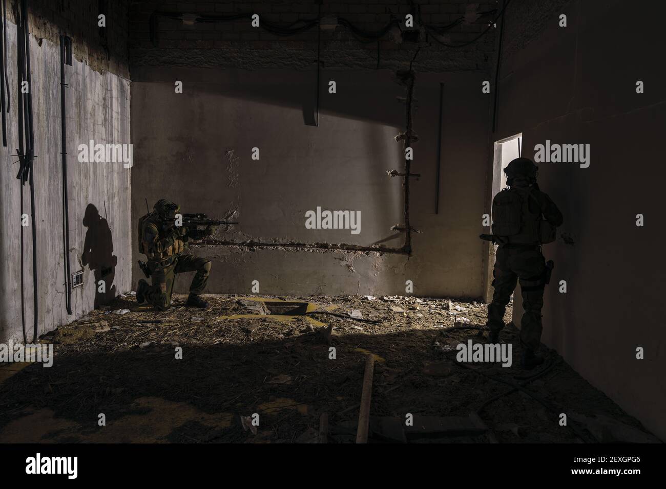 A group of special force soldiers hiding in a room while investigating ...