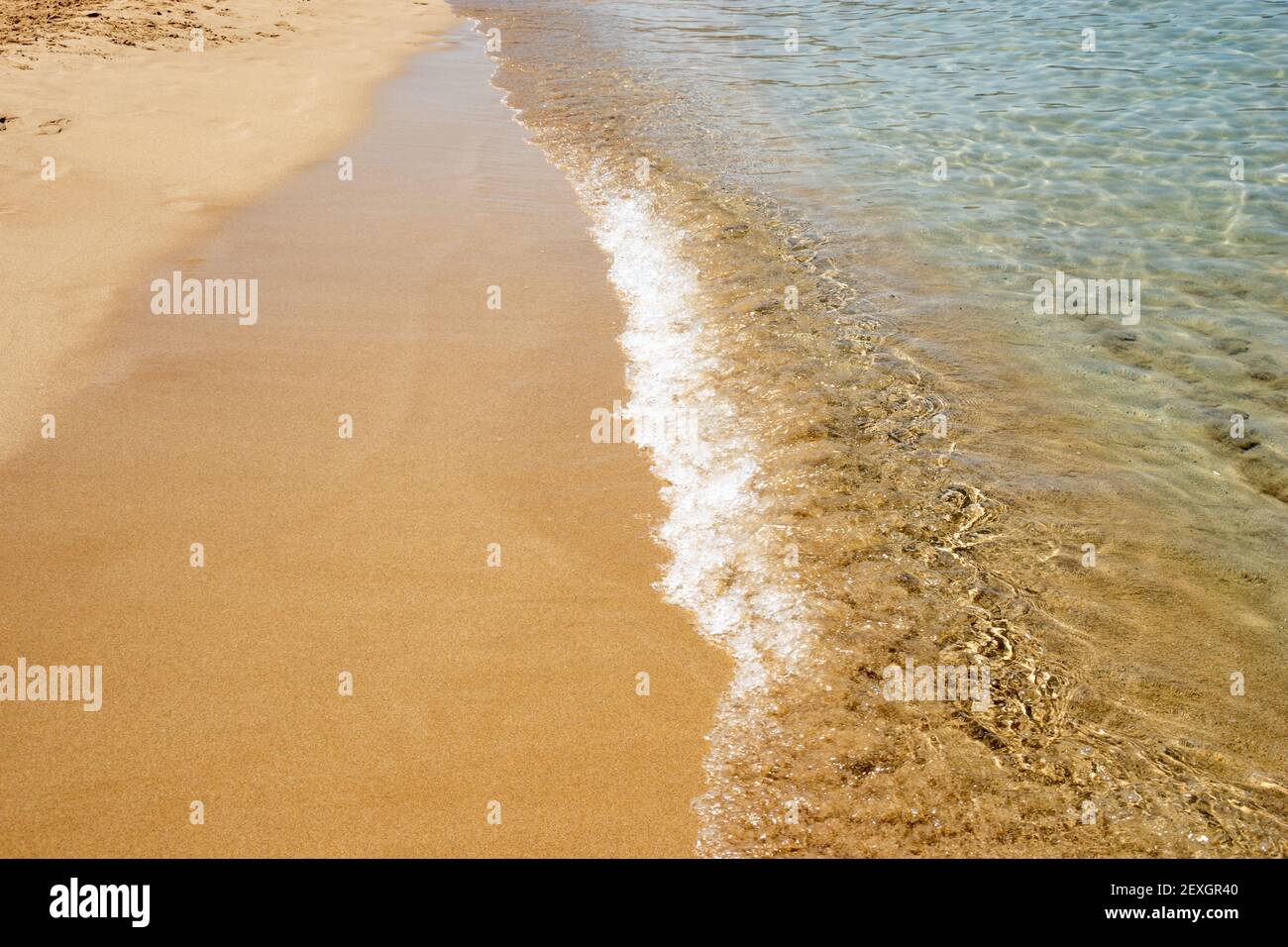 Mesmerizing shot of soft waves on a sandy beach Stock Photo - Alamy