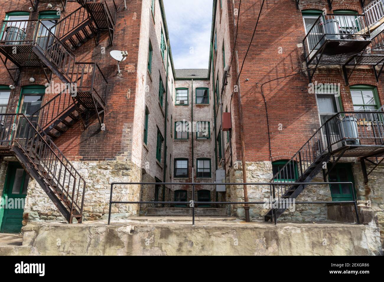 Lightwell within an old apartment building flanked by metal fire ...