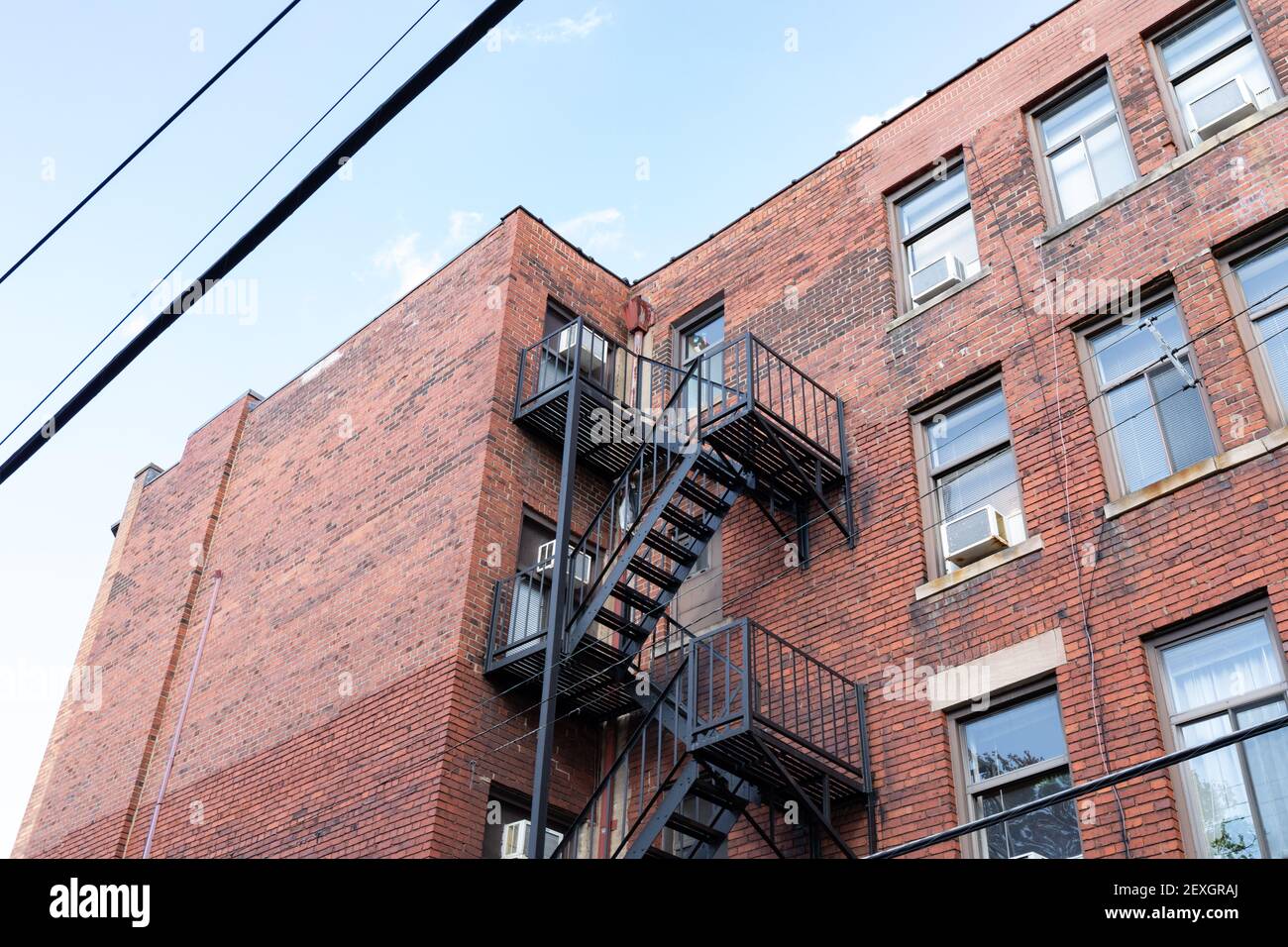 Oblique upward view of an old, generic apartment building with metal ...