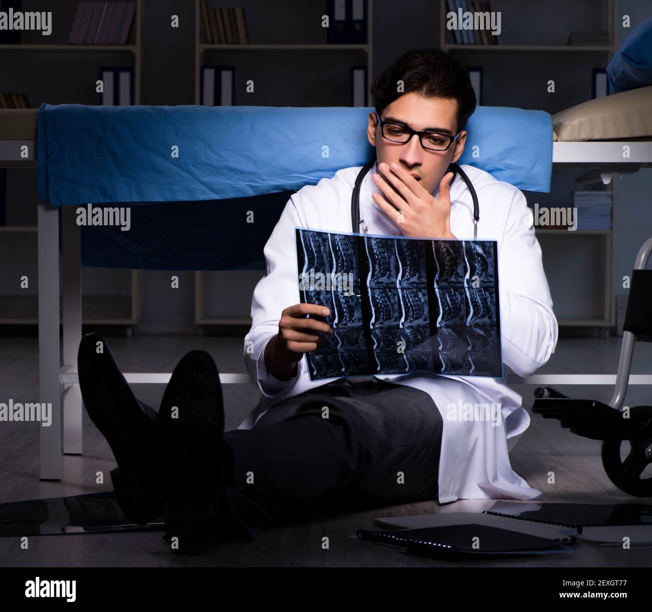 The doctor working night shift in hospital after long hours Stock Photo ...