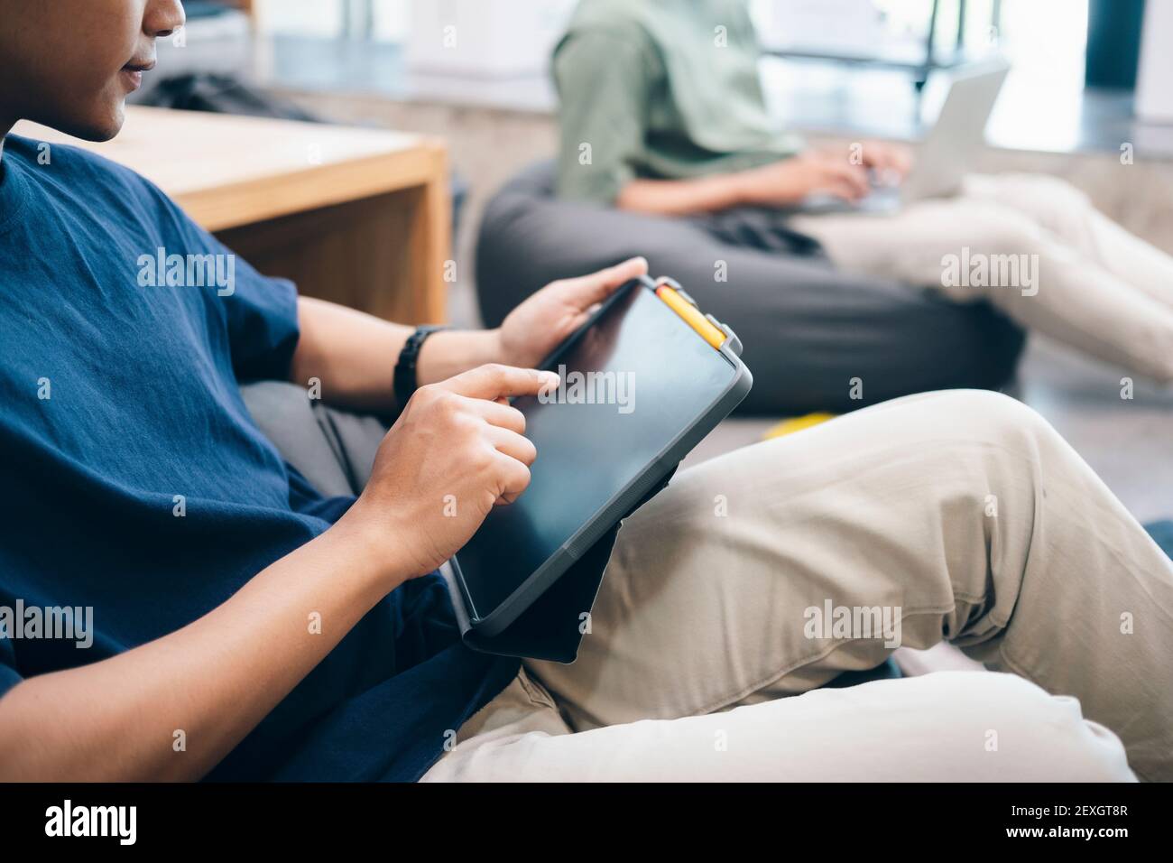 Young collage student using computer and mobile device studying Stock ...