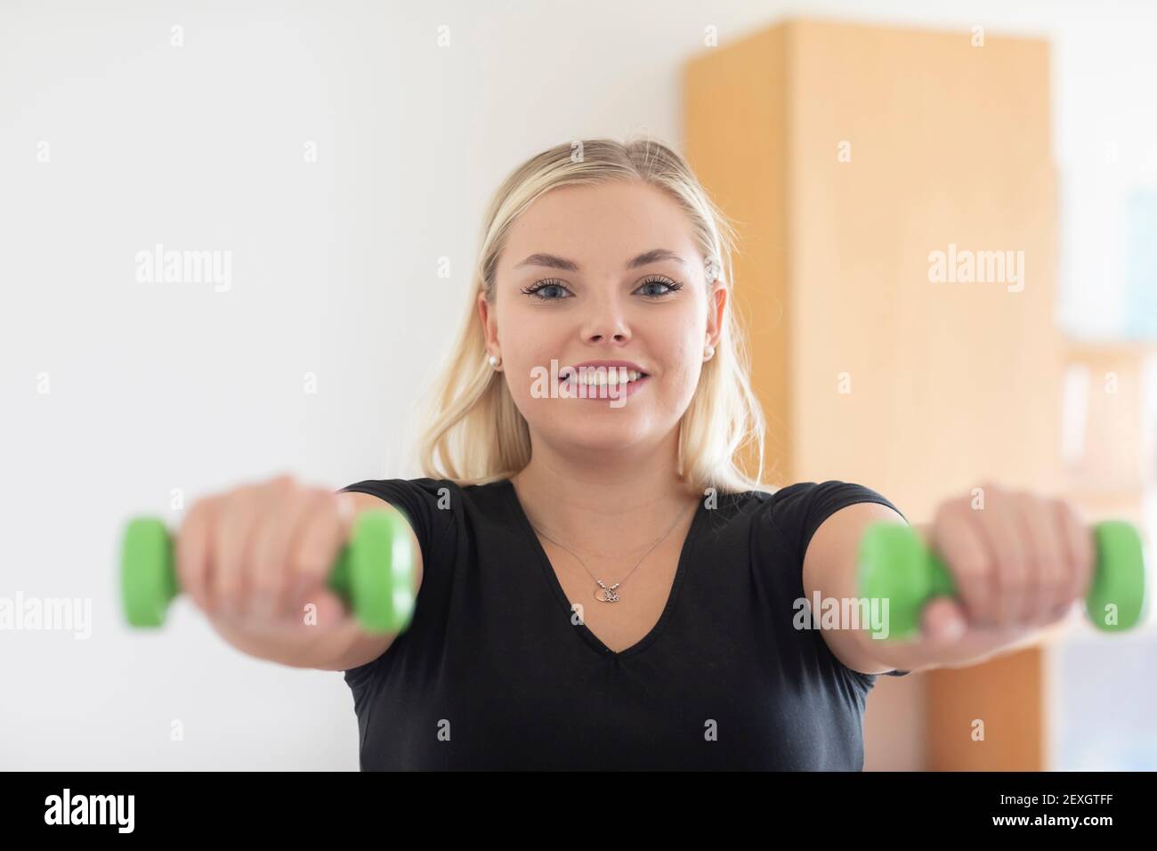 Young woman making sport at home Stock Photo - Alamy