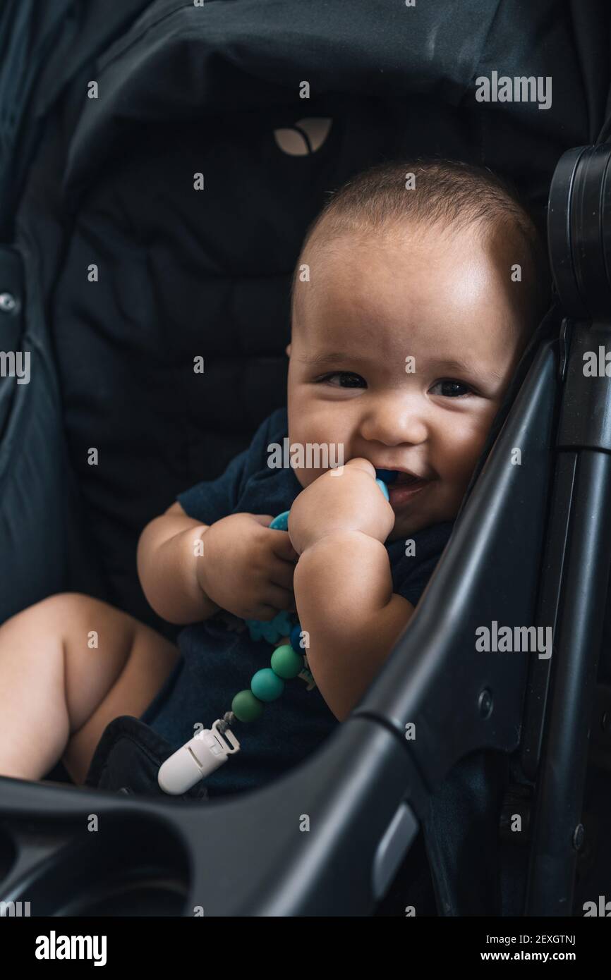 Happy Baby In The Stroller Portraits Stock Photo - Alamy