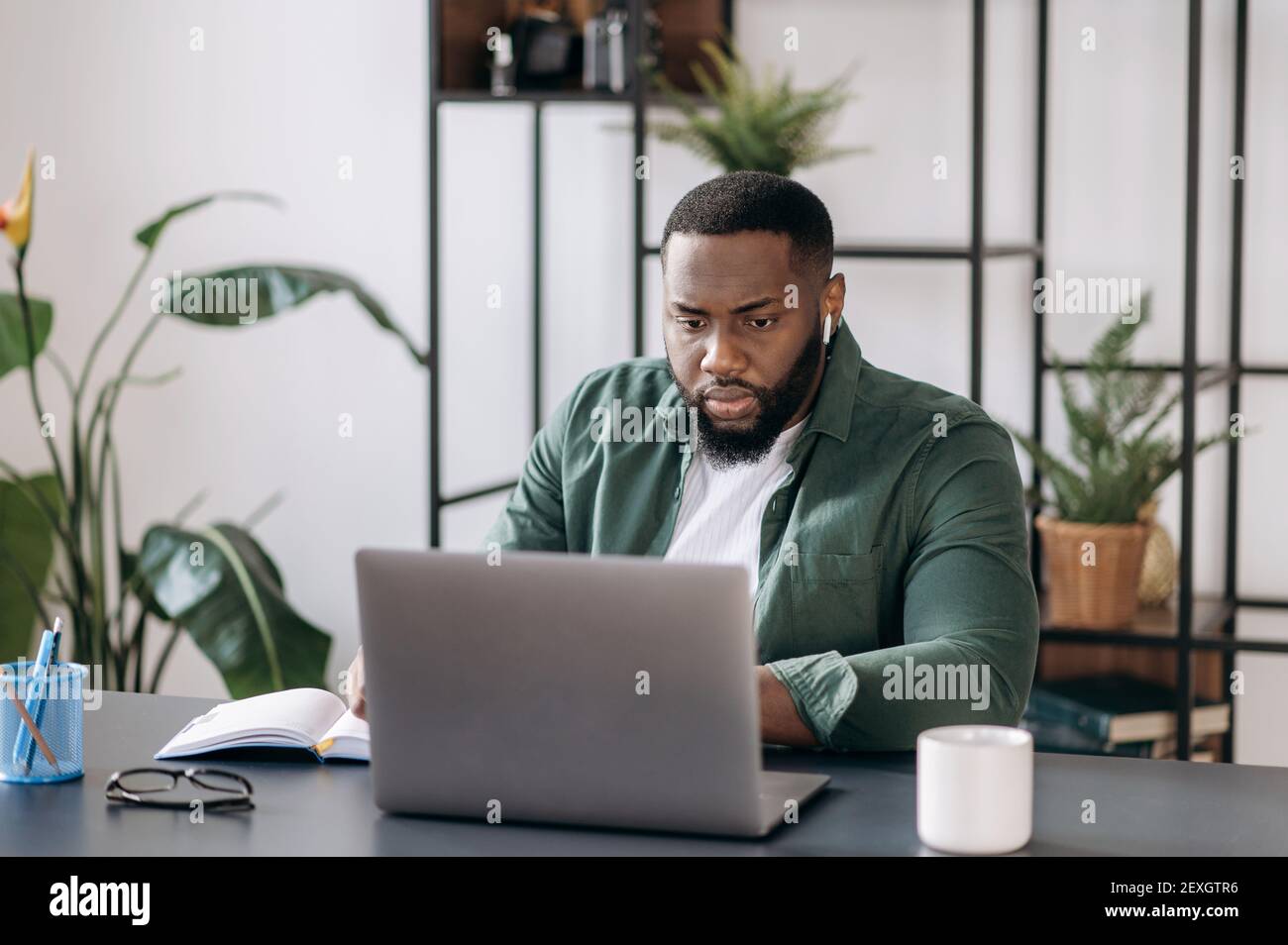 Concentrated serious young successful multiracial black ceo, programmer ...