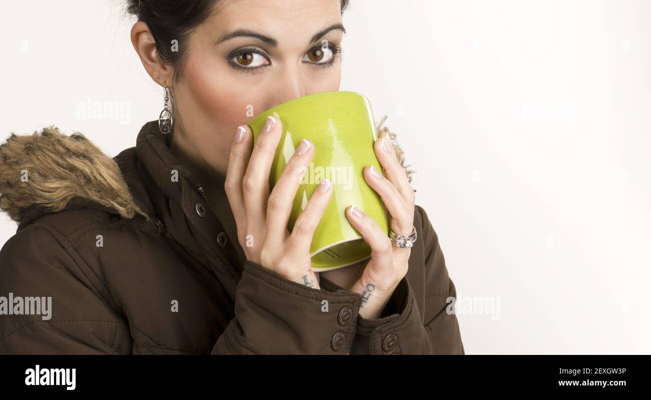 Winter Woman Sipping Coffee Cup Stock Photo - Alamy