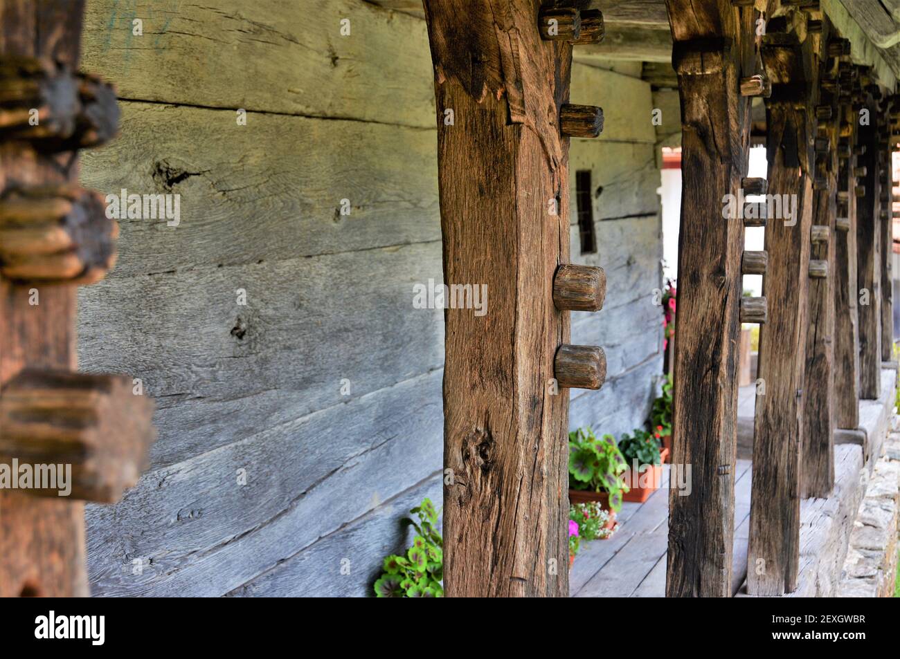 The wooden columns forming a corridor in a building Stock Photo - Alamy