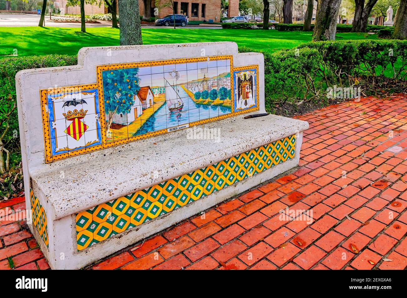 A tile mosaic bench stands in front of the fountain at Spanish Plaza ...