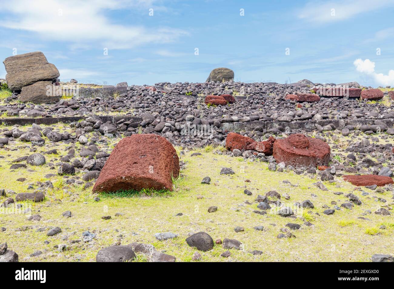 Fallen toppled moai (statues) and red pukao (topknots) at Ahu Akahanga ...