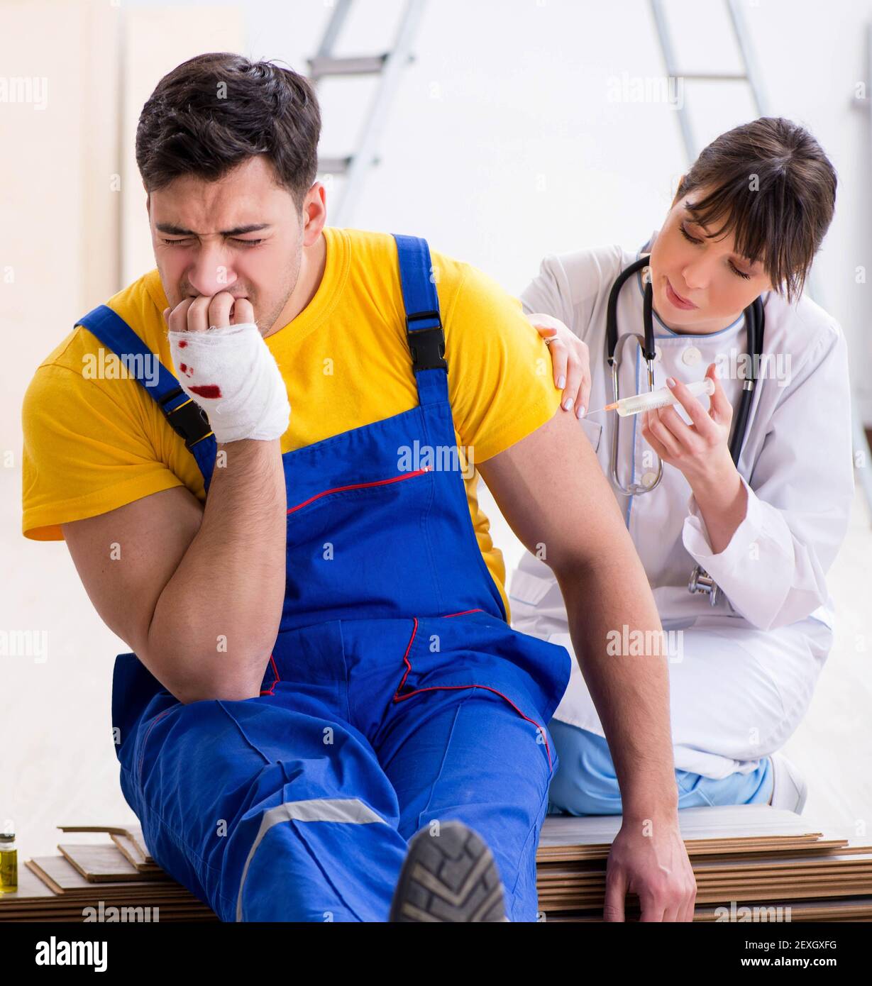 The injured worker being assisted by doctor Stock Photo - Alamy