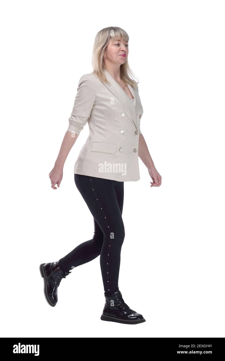 casual woman in a white jacket striding forward Stock Photo - Alamy