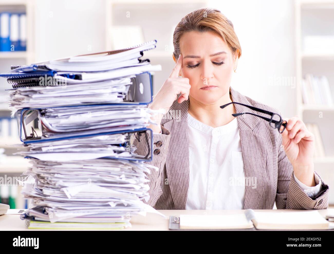 The businesswoman very busy with ongoing paperwork Stock Photo - Alamy