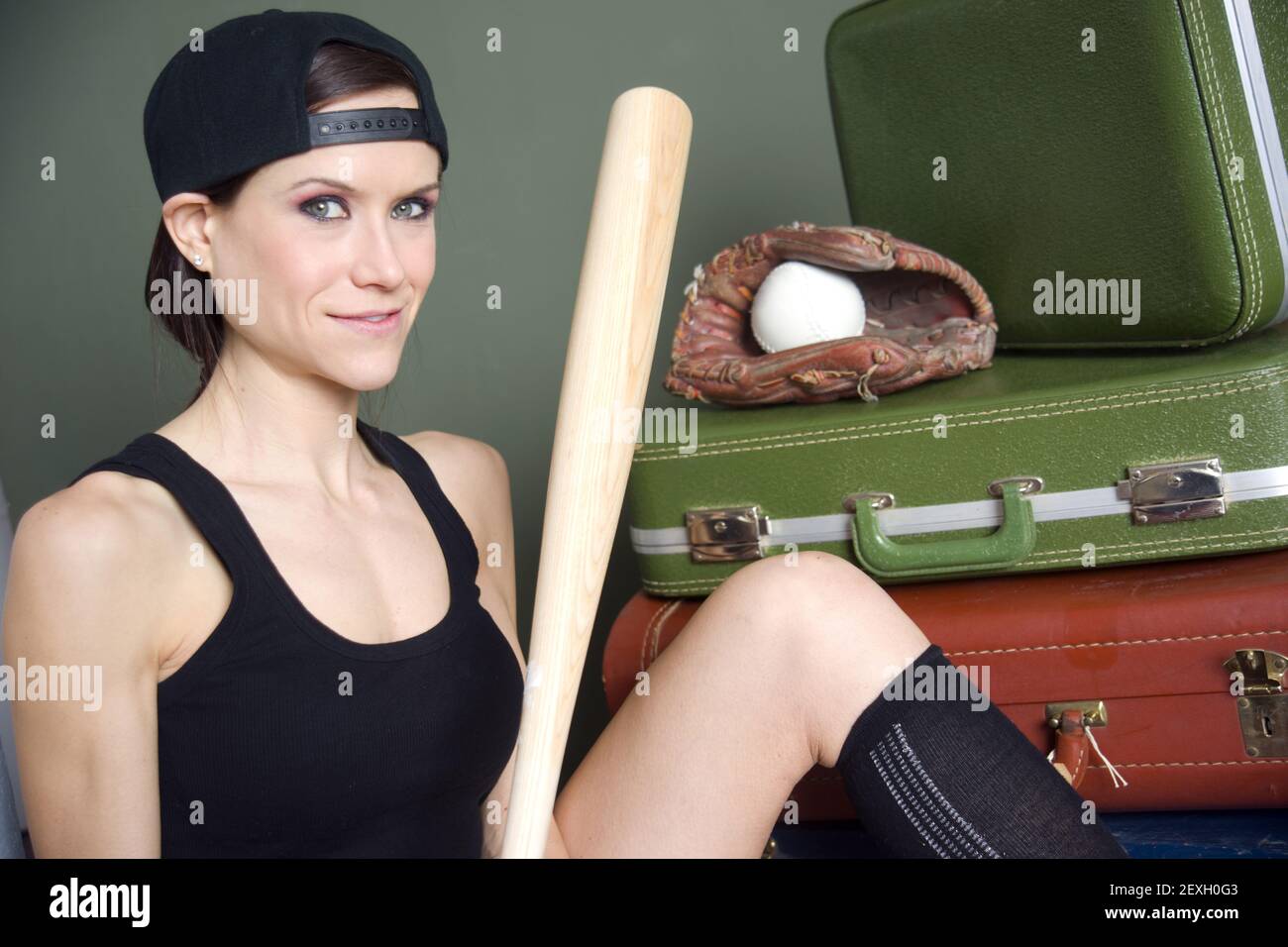 Atractive Female Baseball Player Sits with Bat and Gear Stock Photo - Alamy