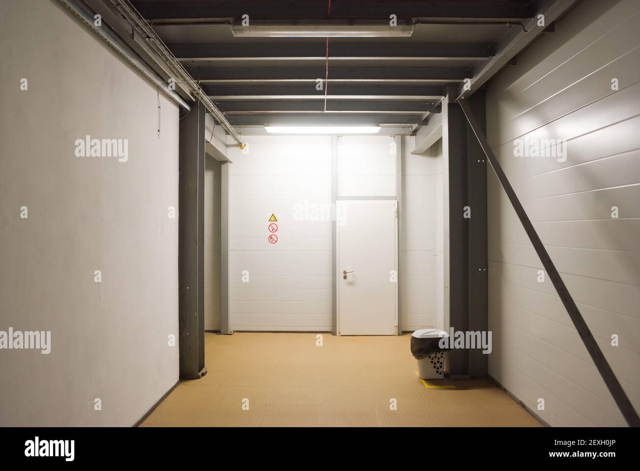 Industrial interior. Empty factory corridor with closed grey door Stock ...