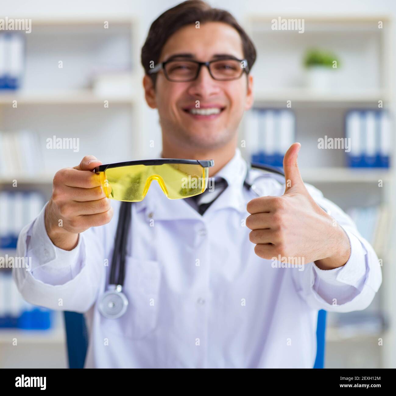 The safety doctor advising about wearing protective goggles Stock Photo ...