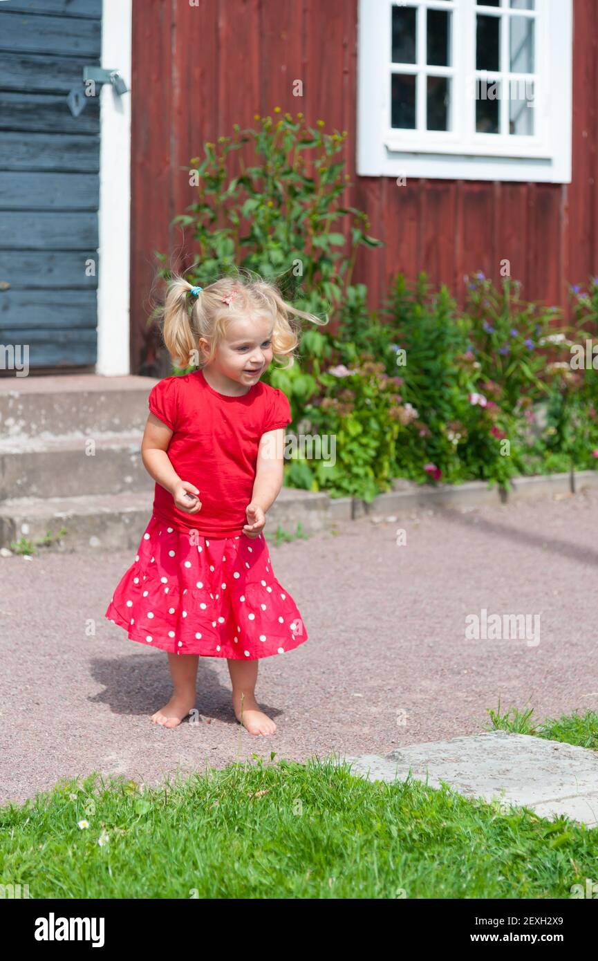 Cute little girl barefoot in sommer Stock Photo - Alamy