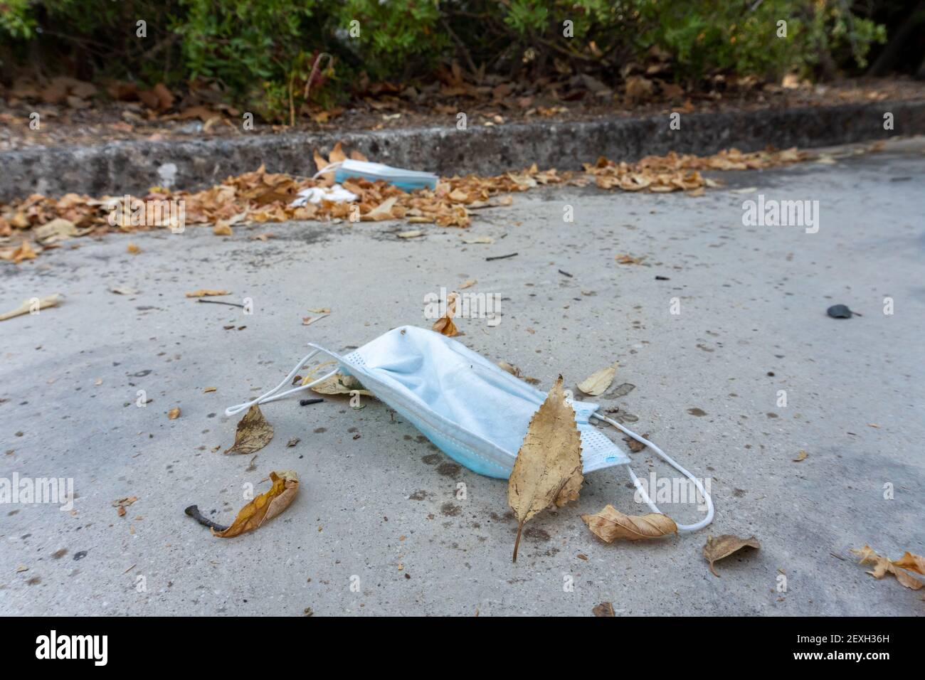 Stock photo of disposable face mask thrown in the floor. Pollution ...