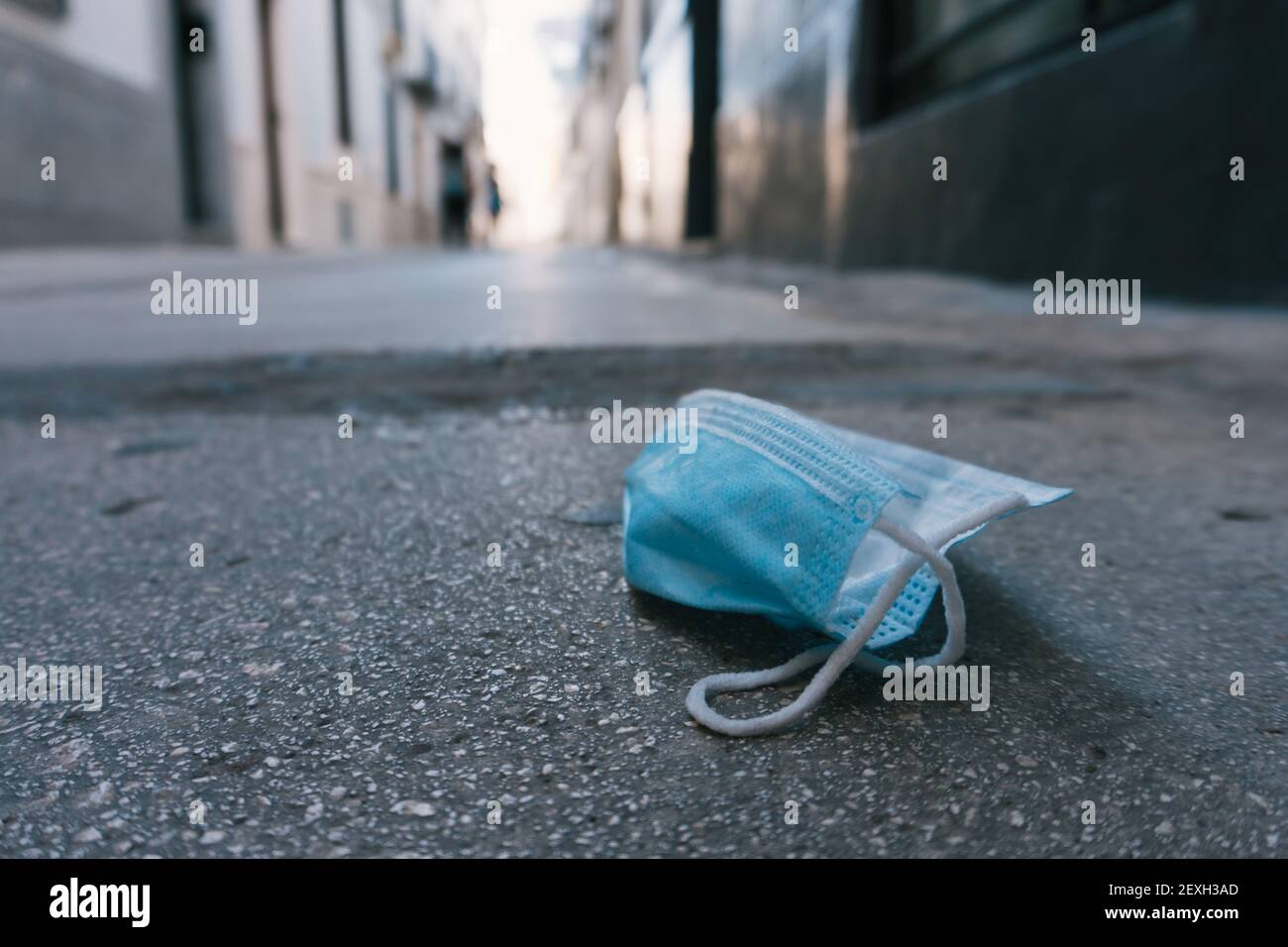 Stock photo of disposable face mask thrown in the floor. Pollution ...