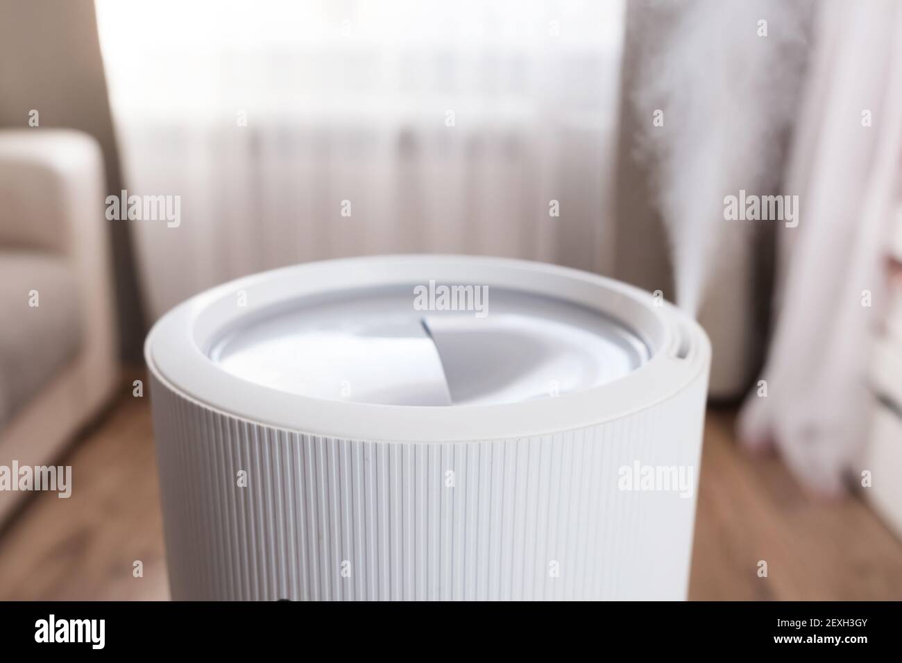 Steam from modern air humidifier, aroma oil diffuser at home. Improving ...