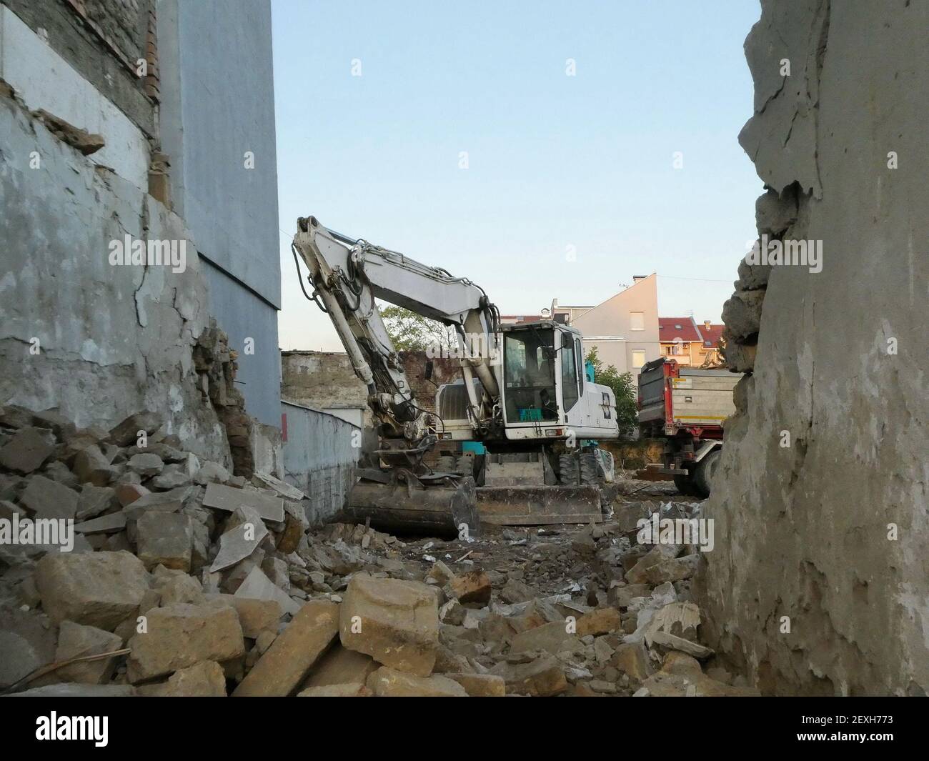 A demolition process of an old building with an excavator in Serbia ...