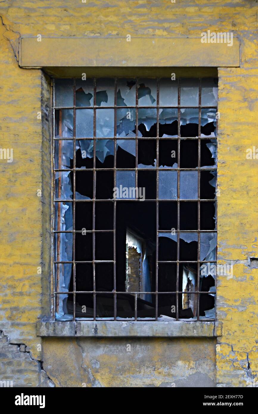 A vertical shot of a broken window of an abandoned building Stock Photo ...
