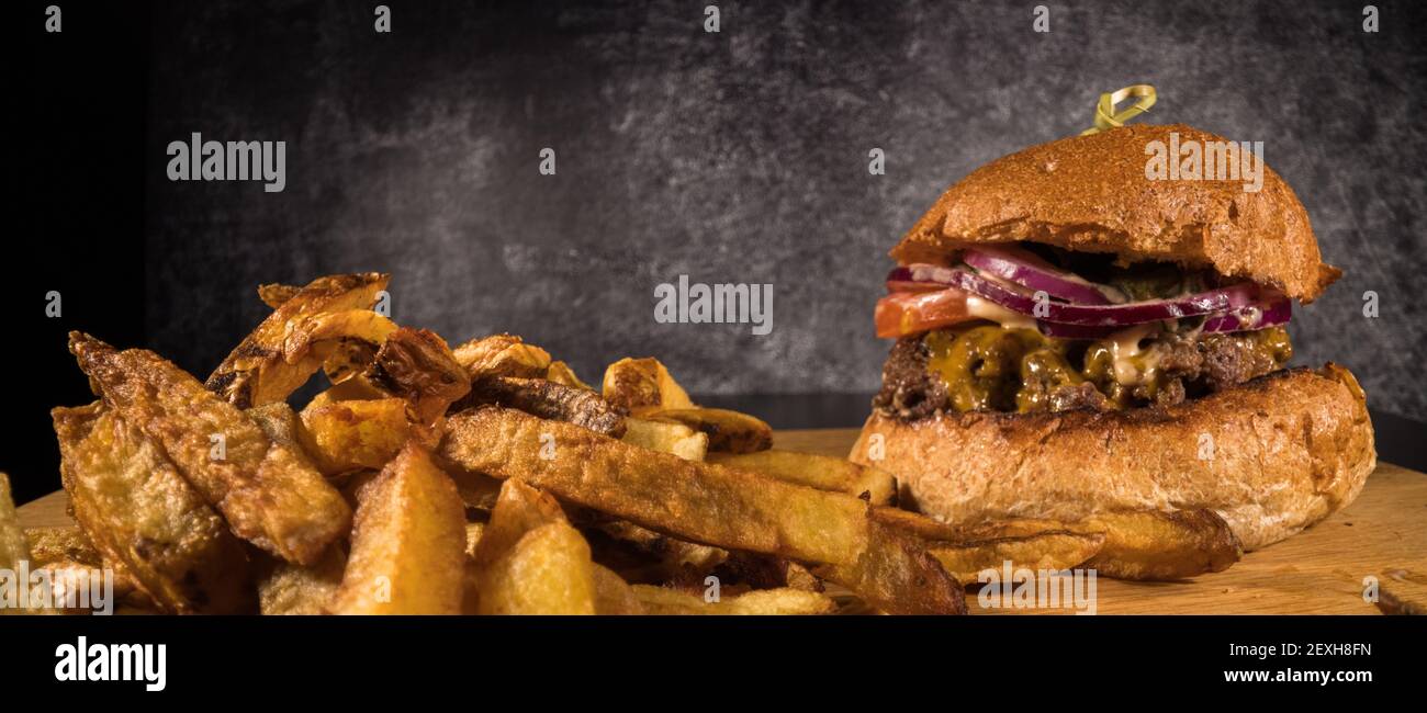 Delicious Cheeseburger with French fries Stock Photo - Alamy