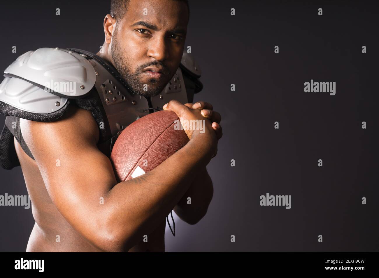 Angry African American Male Football Player Holds Ball Tight Stock ...