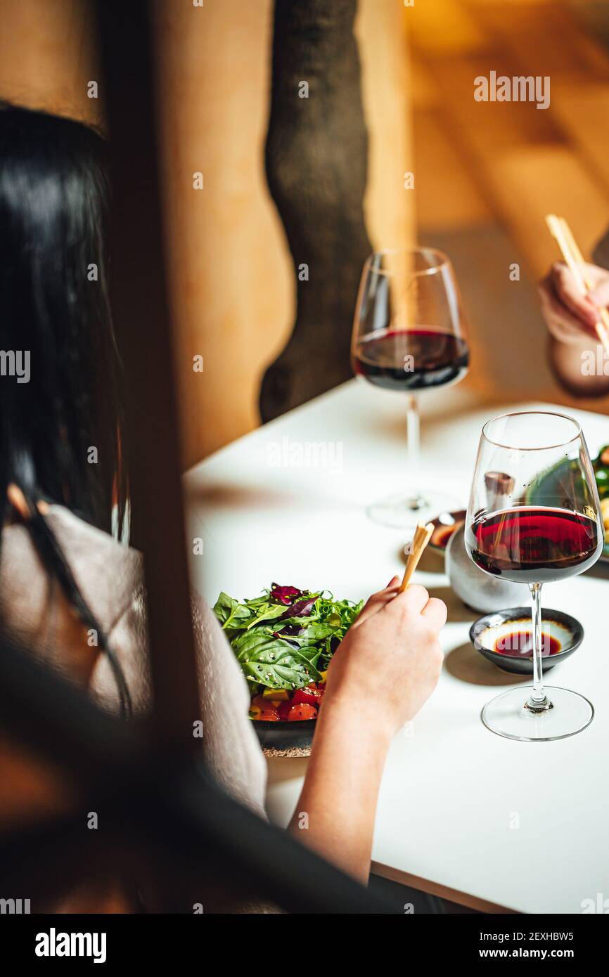 A couple having dinner and drinking red wine in a restaurant Stock ...
