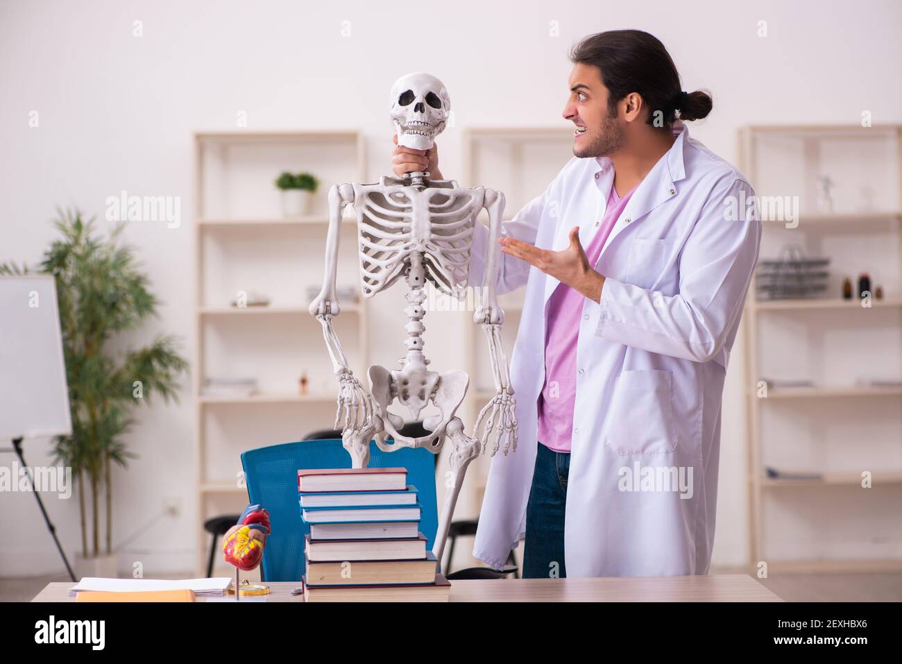 Young doctor student studying human skeleton in the classroom Stock ...