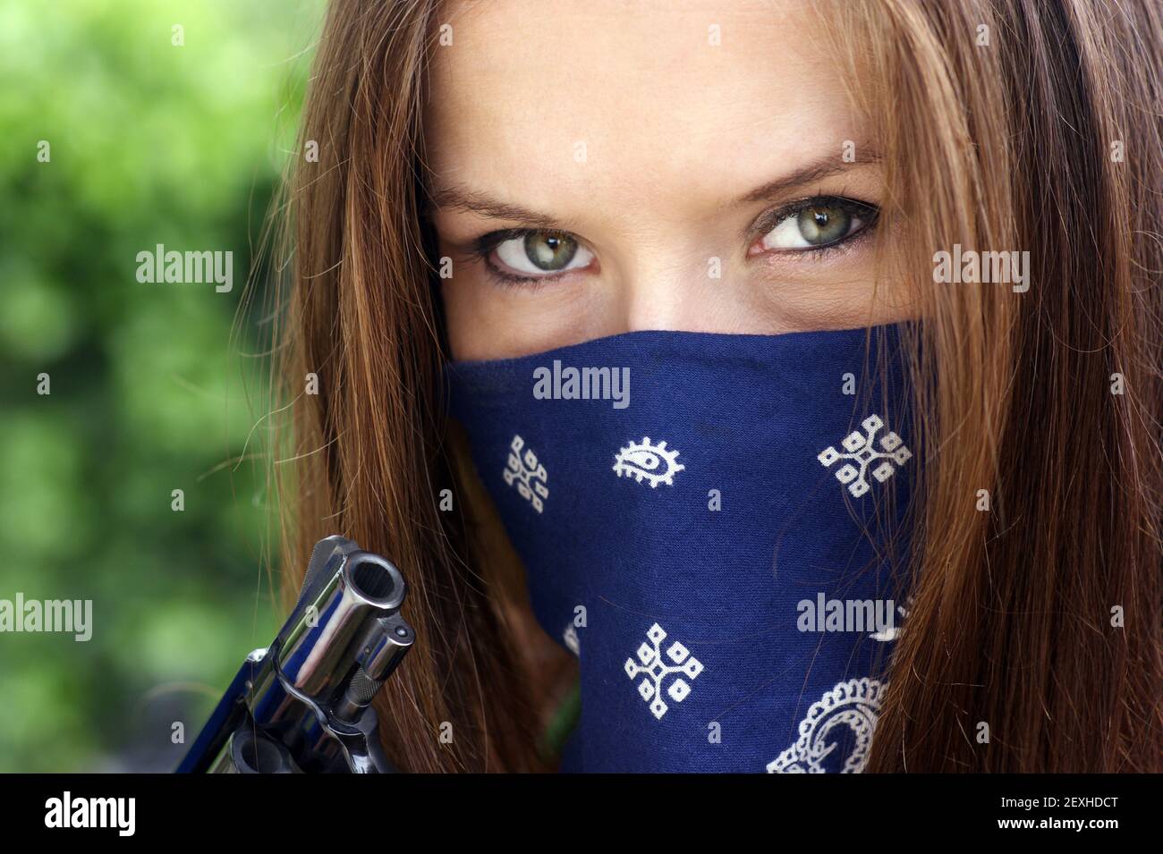 Gun Bandit Woman in Bandanna Holds Black Revolver Stock Photo - Alamy
