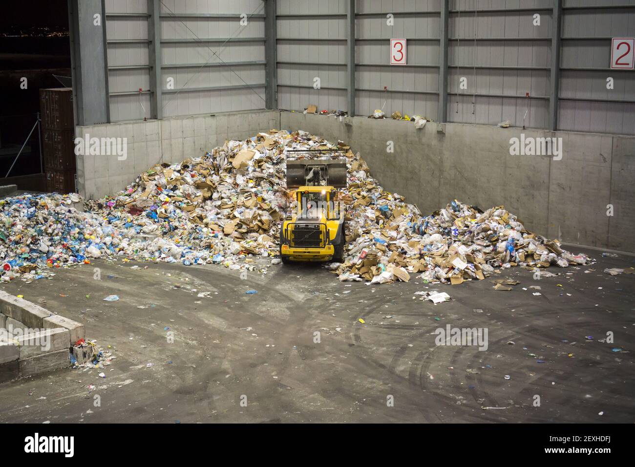 A front loader moves mountains of trash in the tipping area from the ...