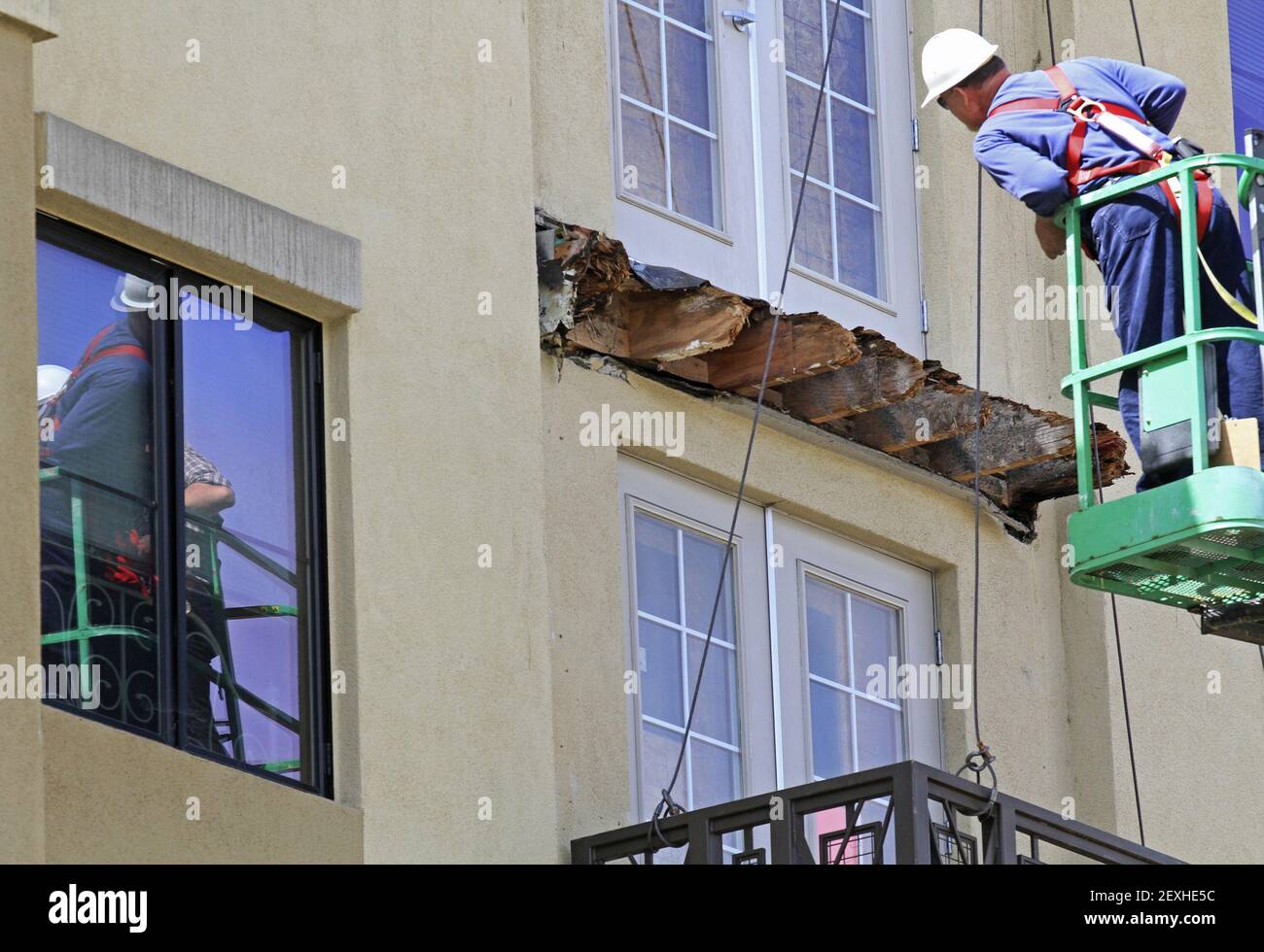 Inspectors in a cherry picker to take photos and measurements of the ...