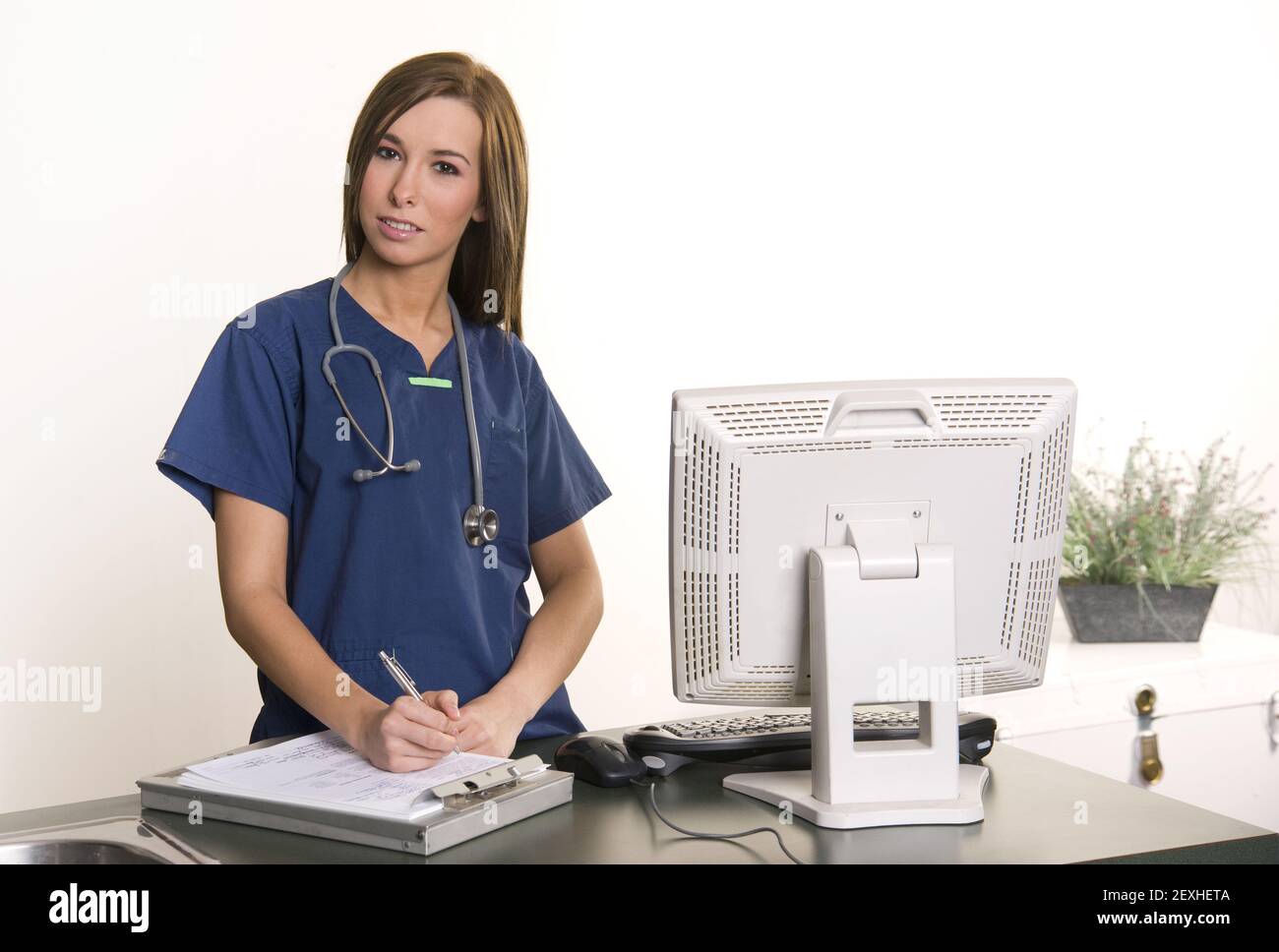Working Nurse Fills Out Chart at Workstation Stock Photo - Alamy