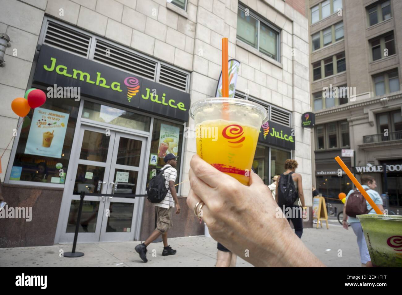 An customer with her Jamba Juice outside a store in the Chelsea ...